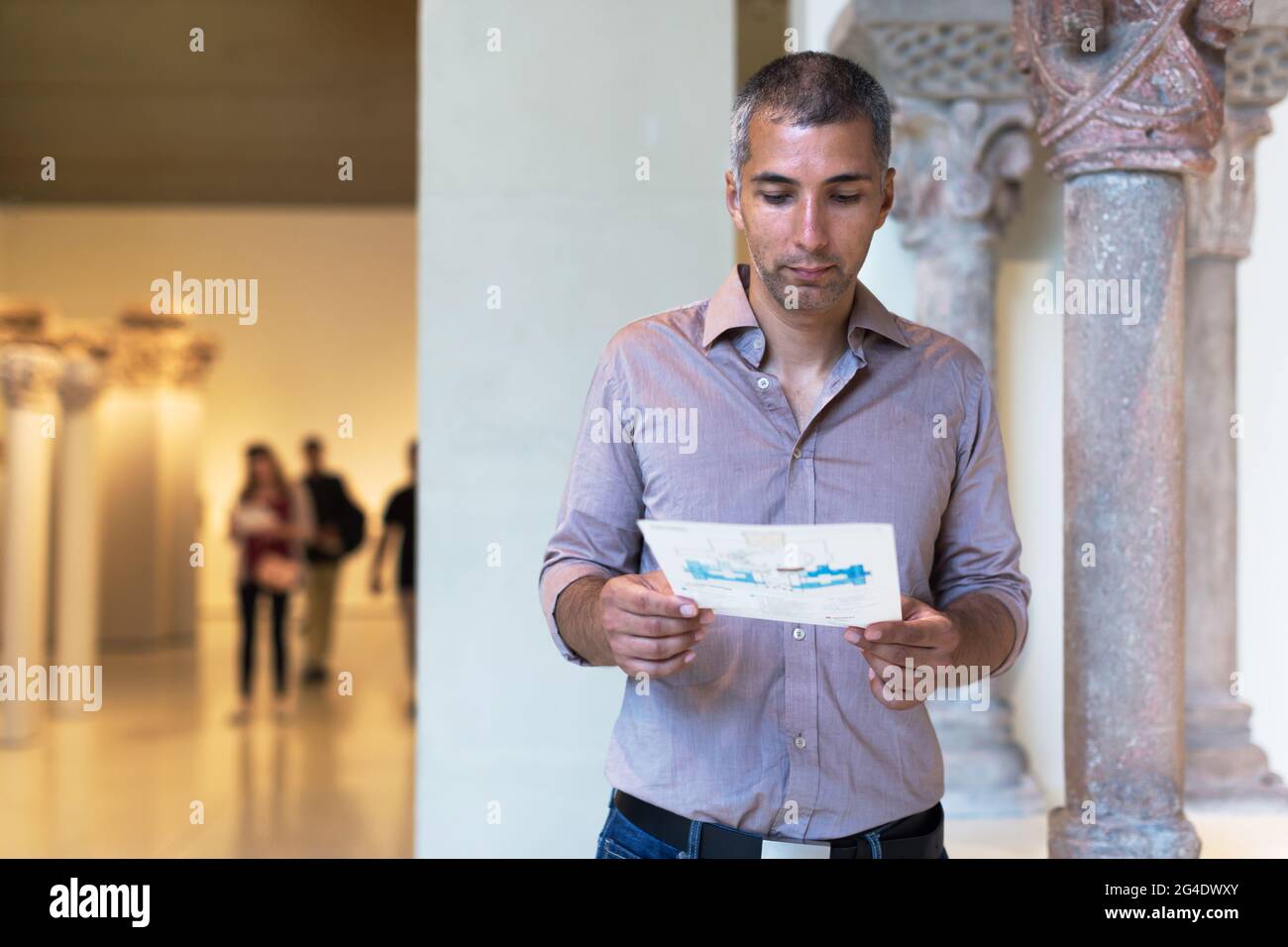 Adult man is visiting museum and looking at the exposition Stock Photo ...
