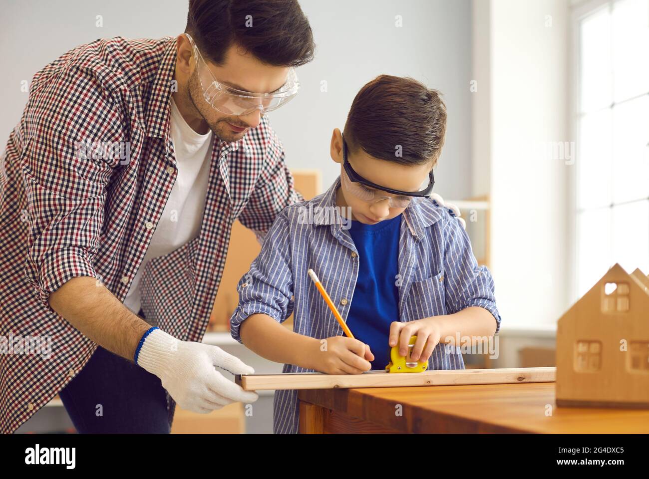 Father handyman and boy son child work at family carpentry home ...