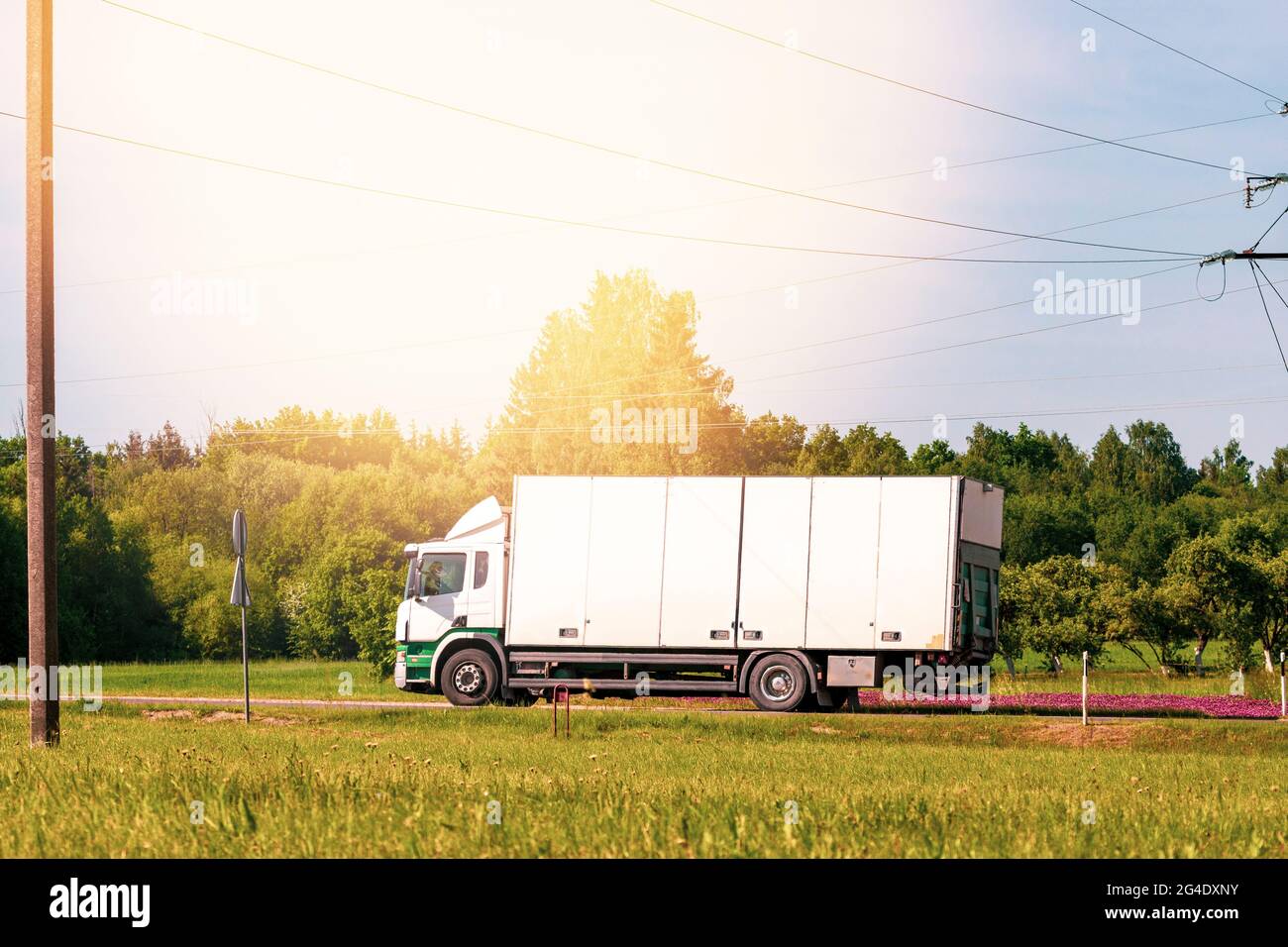 White semi truck with cargo drives on the empty road Stock Photo - Alamy