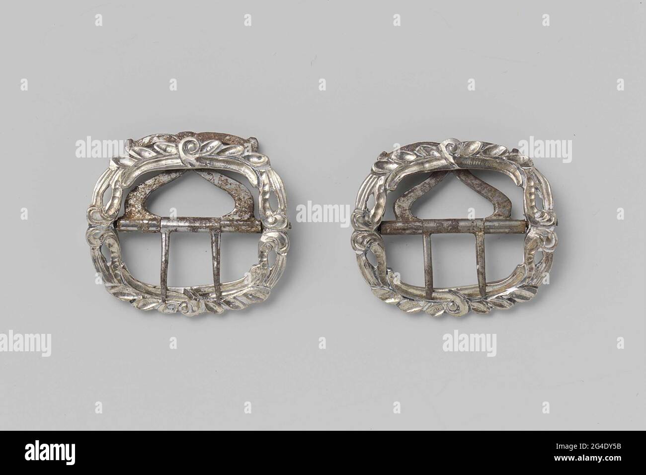 . Buckle of silver with decorated edge and a hinged part that two teeth ...