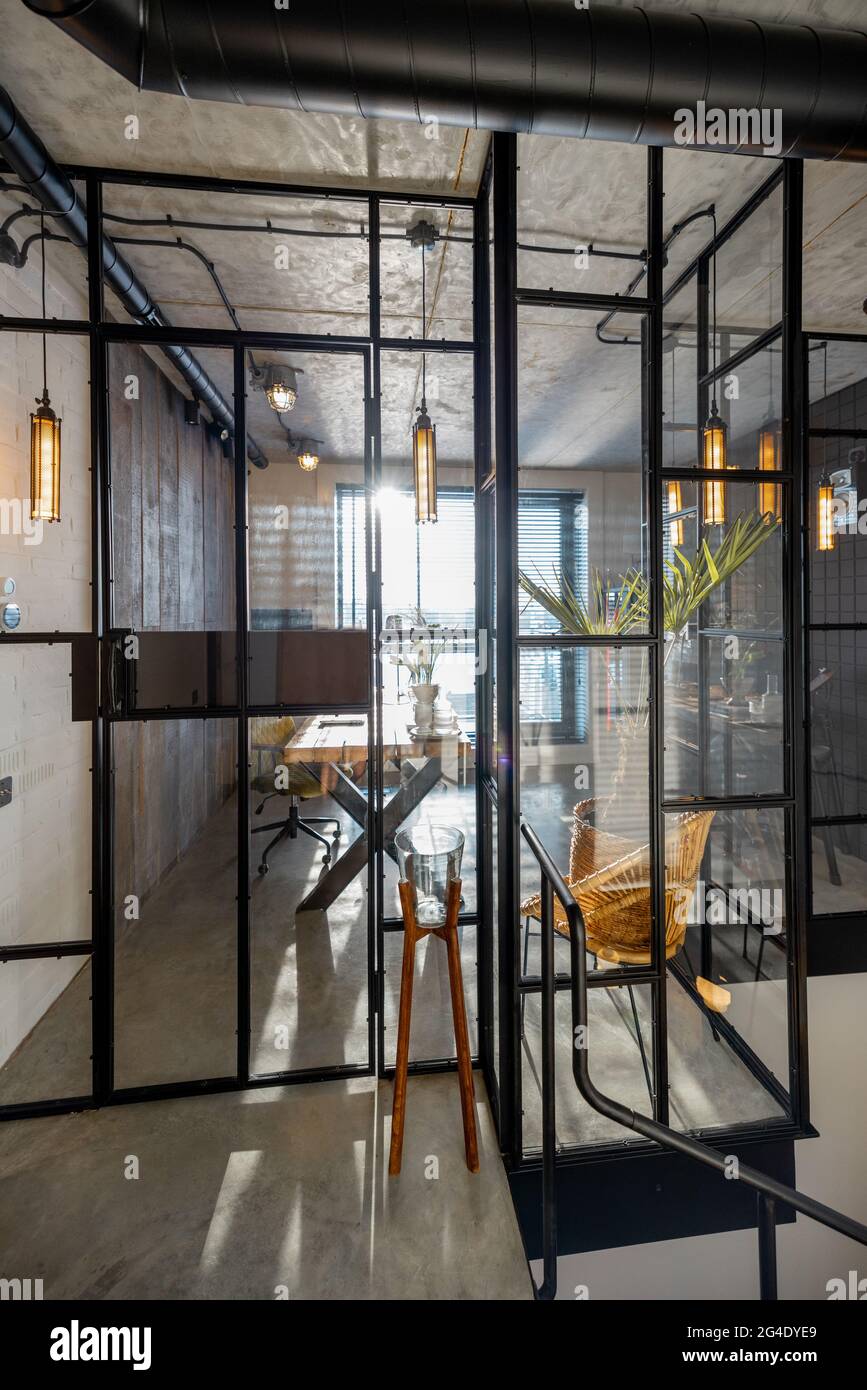Glass partition to the home office in loft style Stock Photo - Alamy