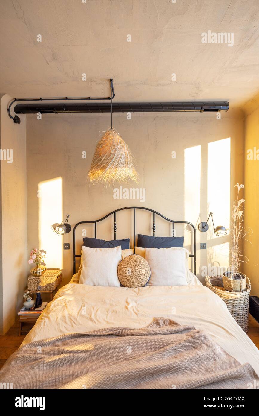 Stylish bedroom interior in natural boho style Stock Photo - Alamy