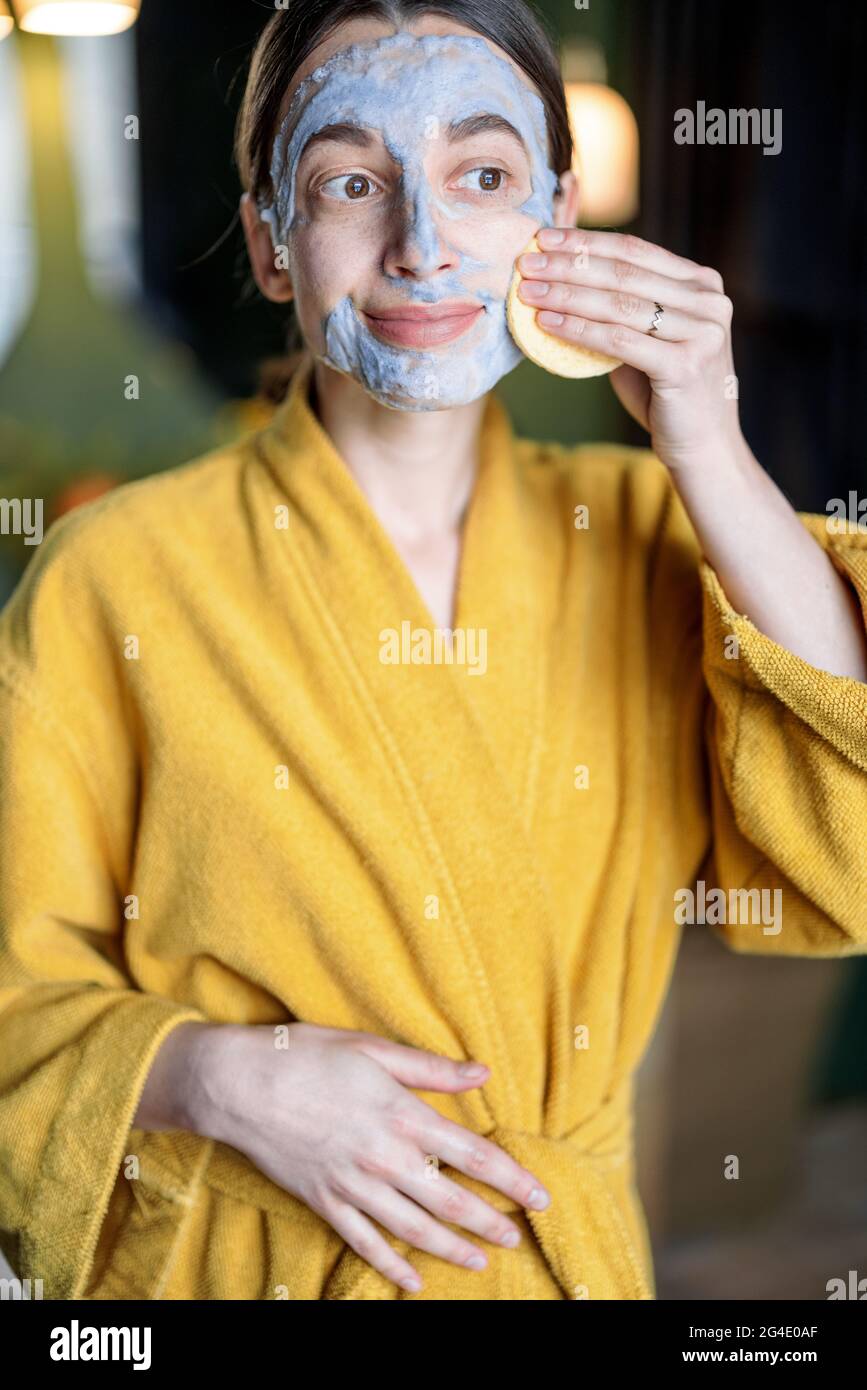 Woman removing cleansing mask from her face Stock Photo - Alamy