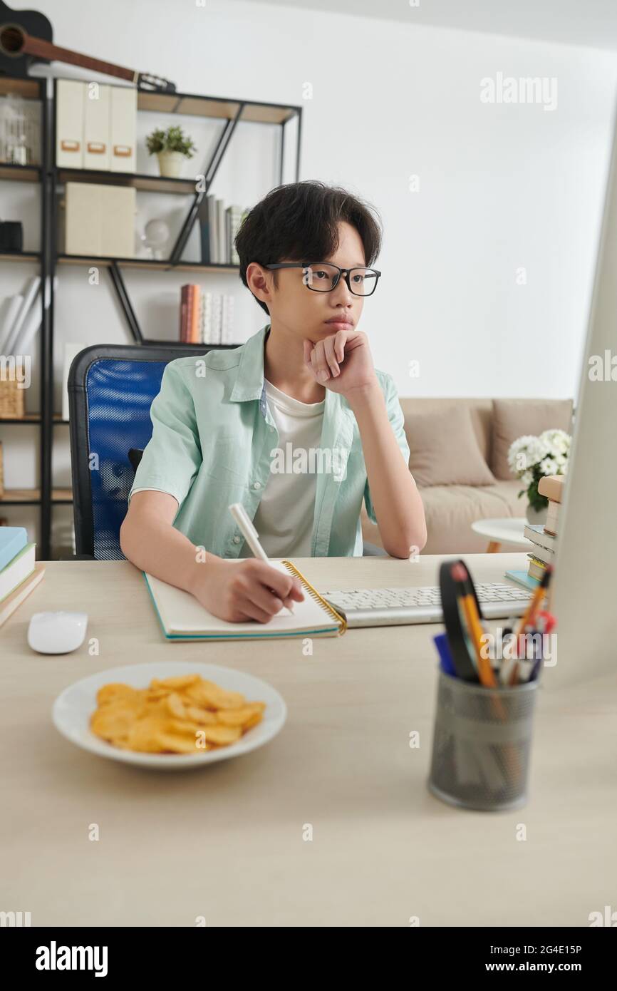 Teenage boy watching computer screen hi-res stock photography and ...