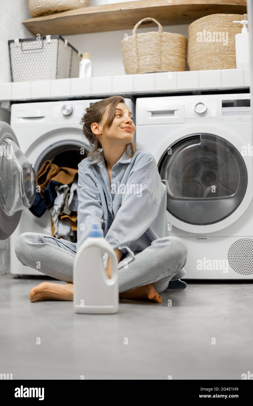 Woman in the laundry room at home Stock Photo - Alamy