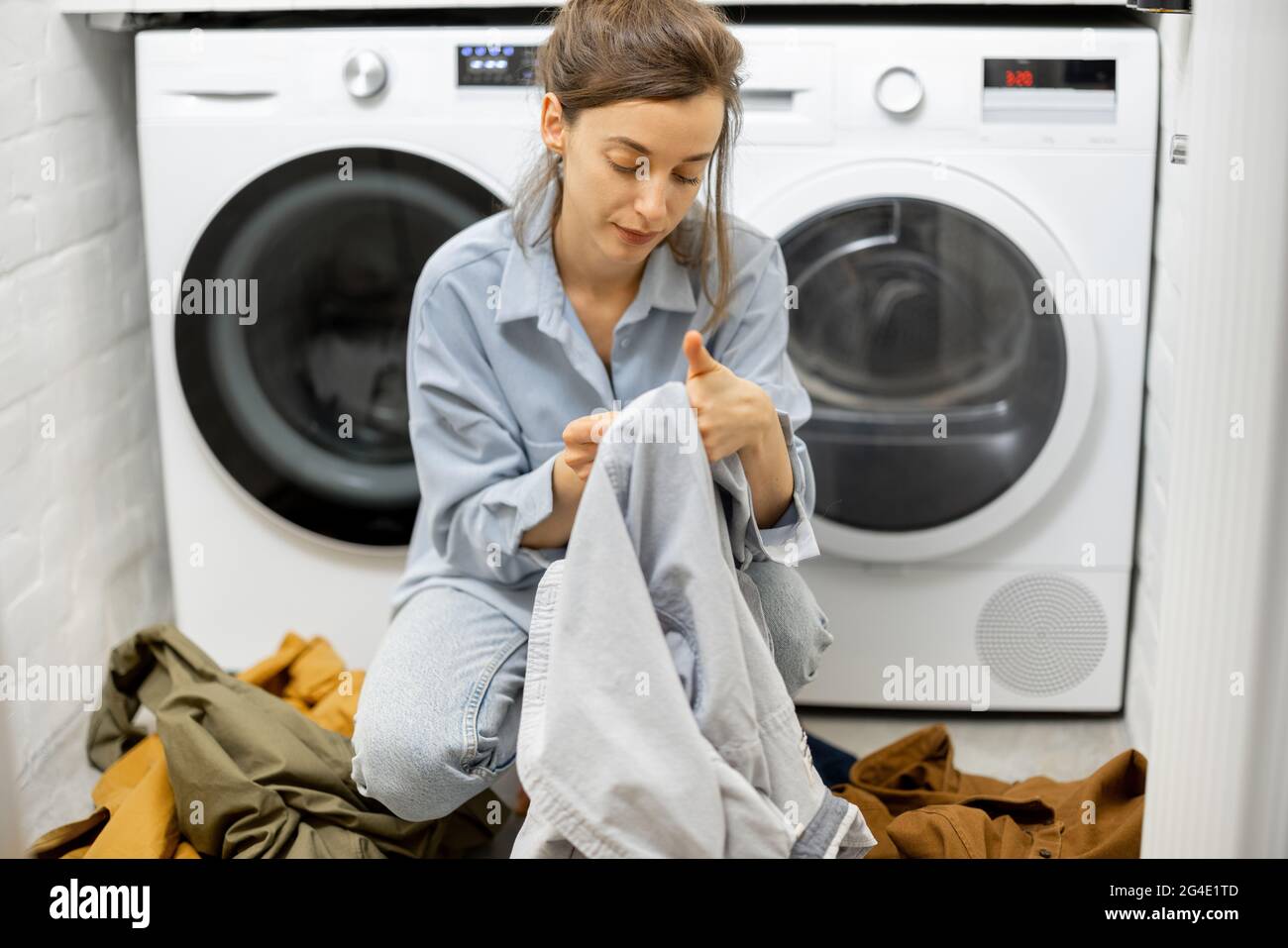 Woman sorting clothes home hi-res stock photography and images - Alamy