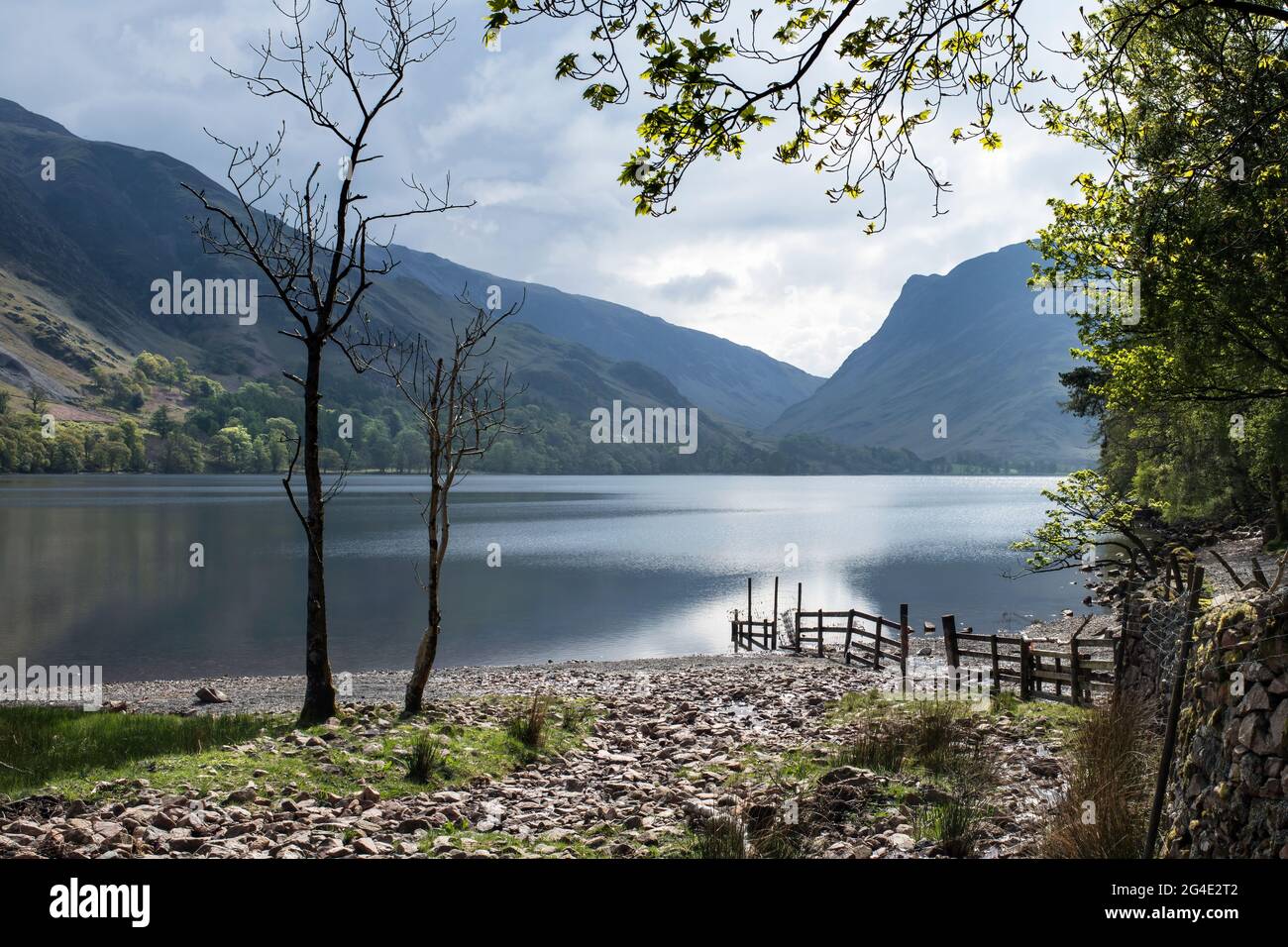 Calm waters of Buttermere with rain clouds forming overhead Stock Photo ...