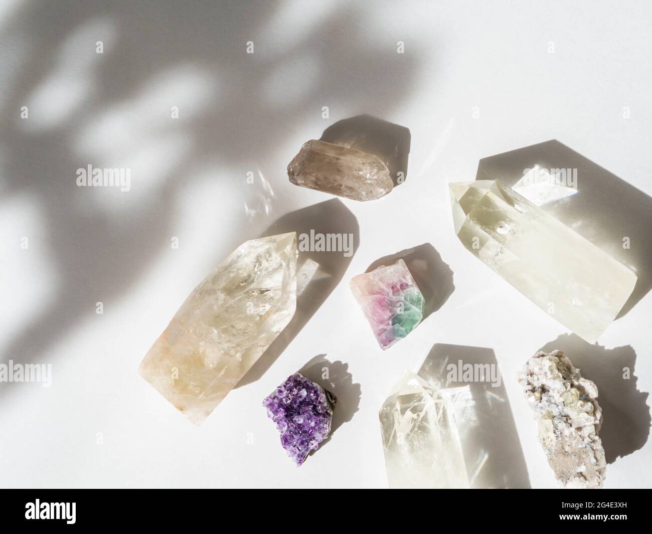 Collection of crystals of minerals on a white background with shadows ...