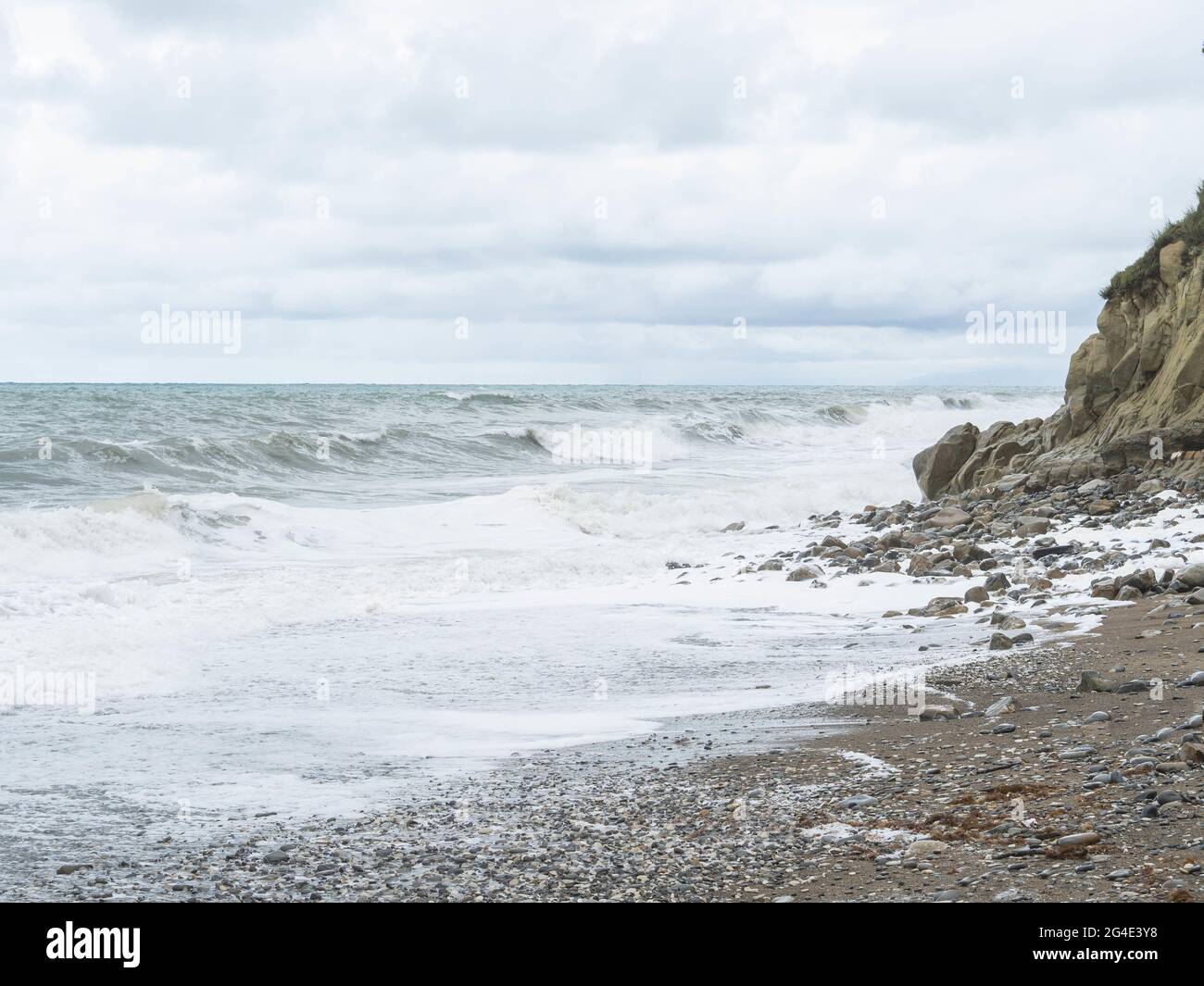 Storm waves on a stone beach in cloudy weather. Nature scenery Stock ...