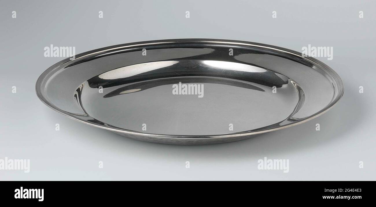 . The round dish has a deepened flat and a wide flat edge, decorated ...