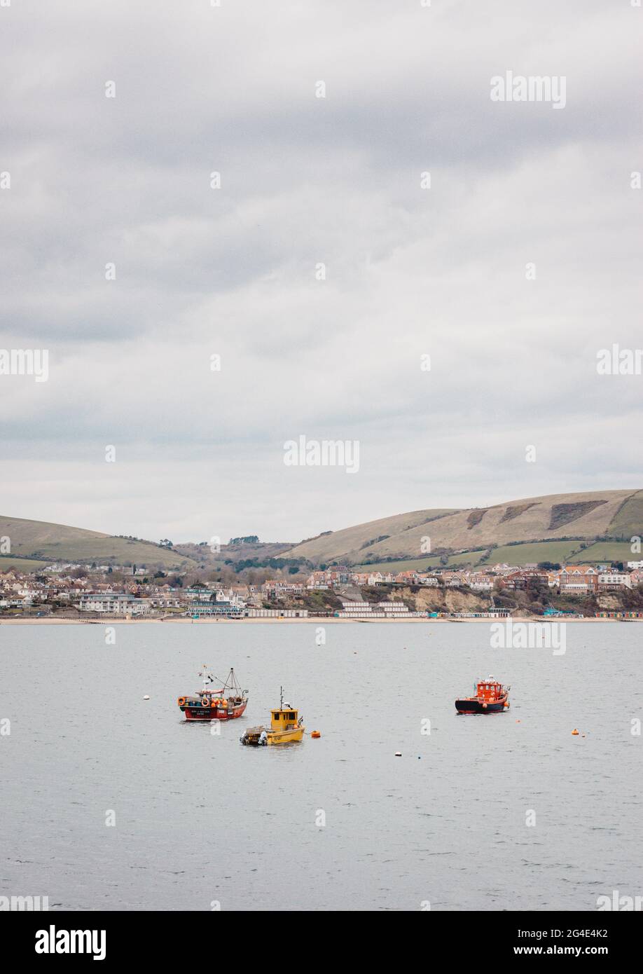 Fishing boats moored in Swanage harbour visible from the coast path ...