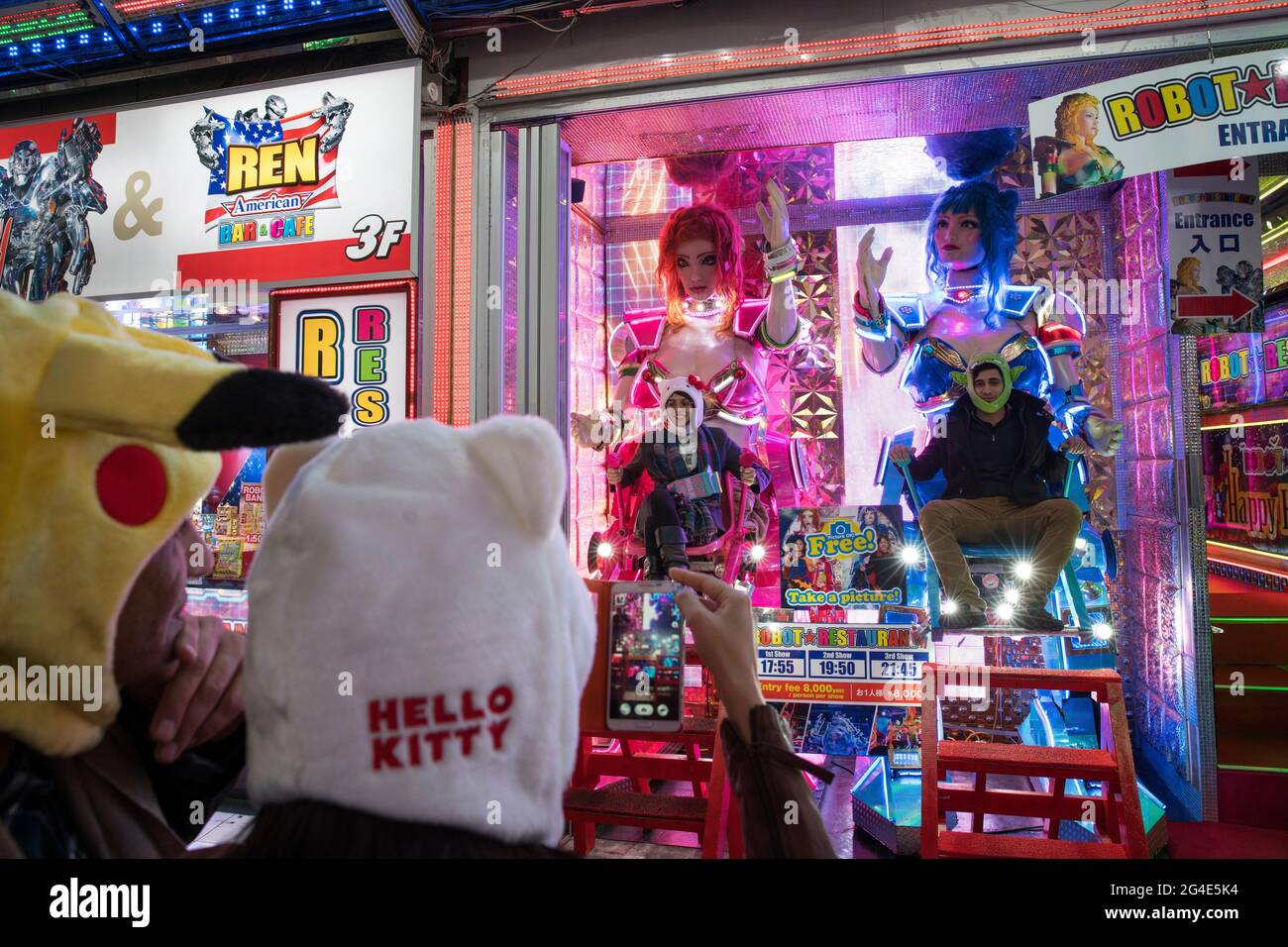 Tourists posing for photos in robots outside the Robot Restaurant in ...