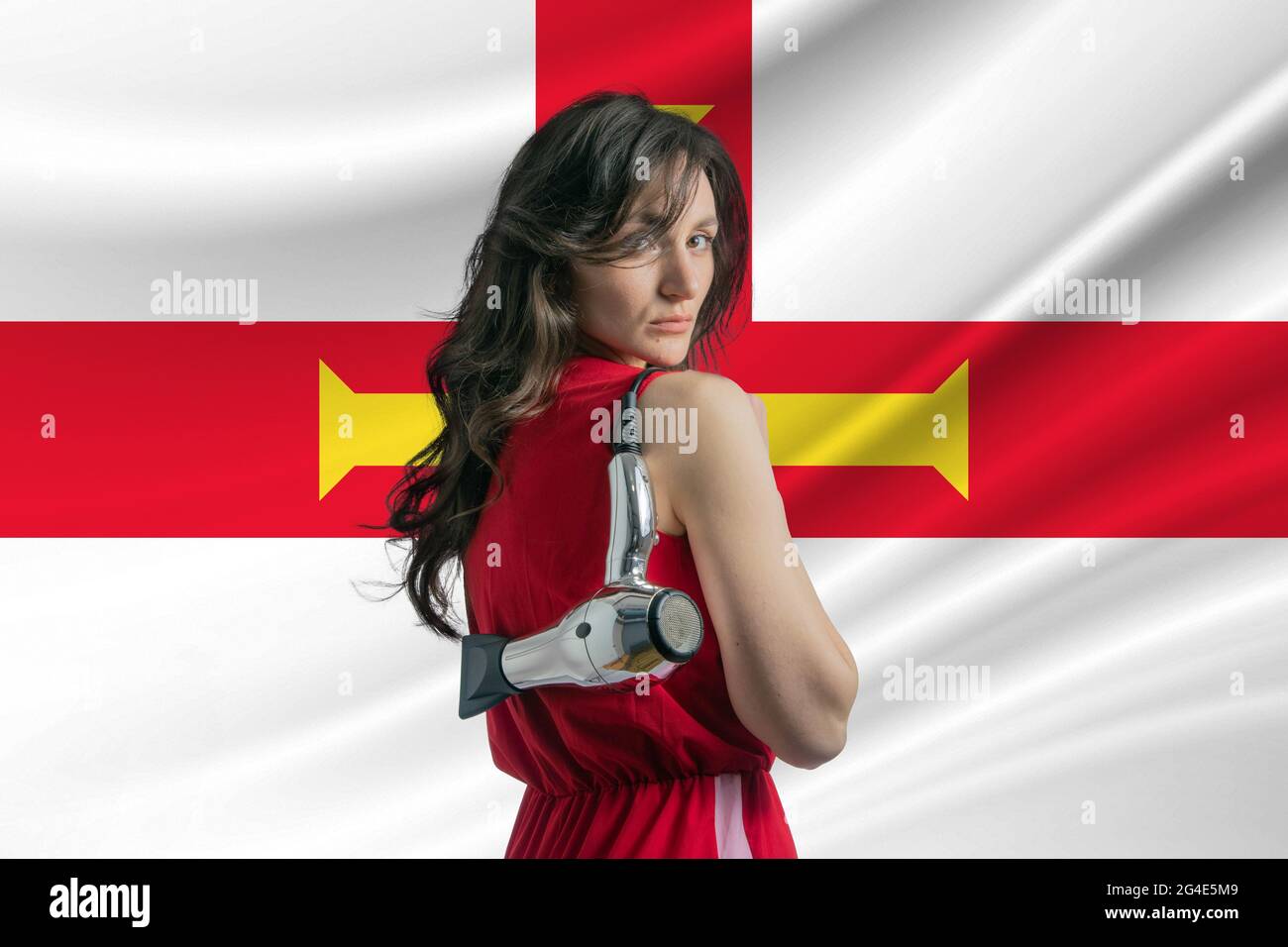 Beauty industry in Guernsey. Happy female hairdresser holding hairdryer ...