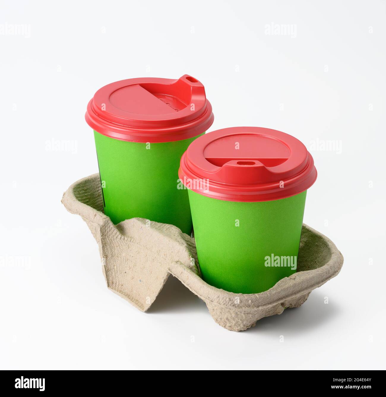 disposable green cups with red plastic lid stand in holder on white ...