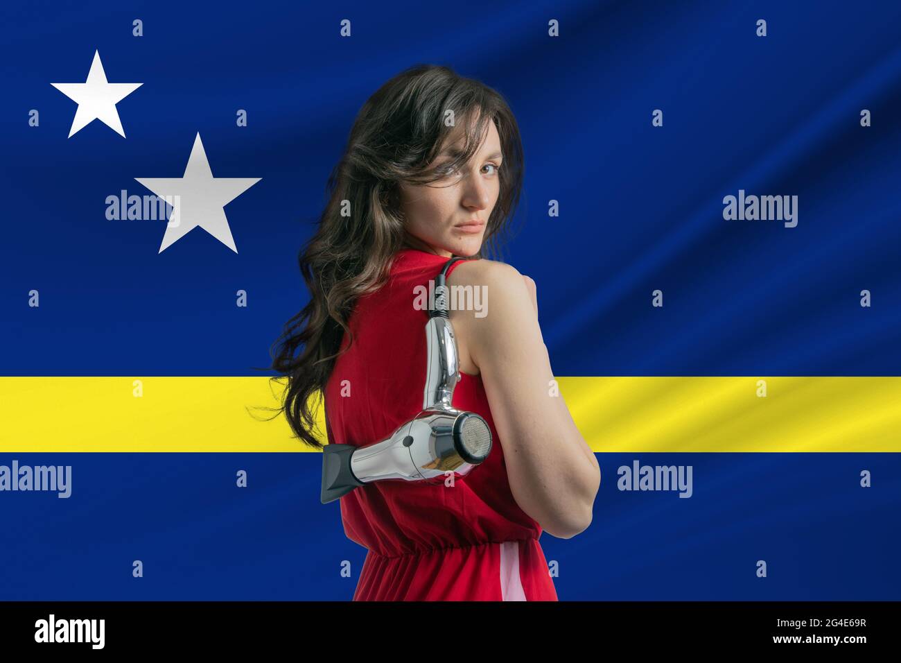 Beauty industry in Curacao. Happy female hairdresser holding hairdryer ...