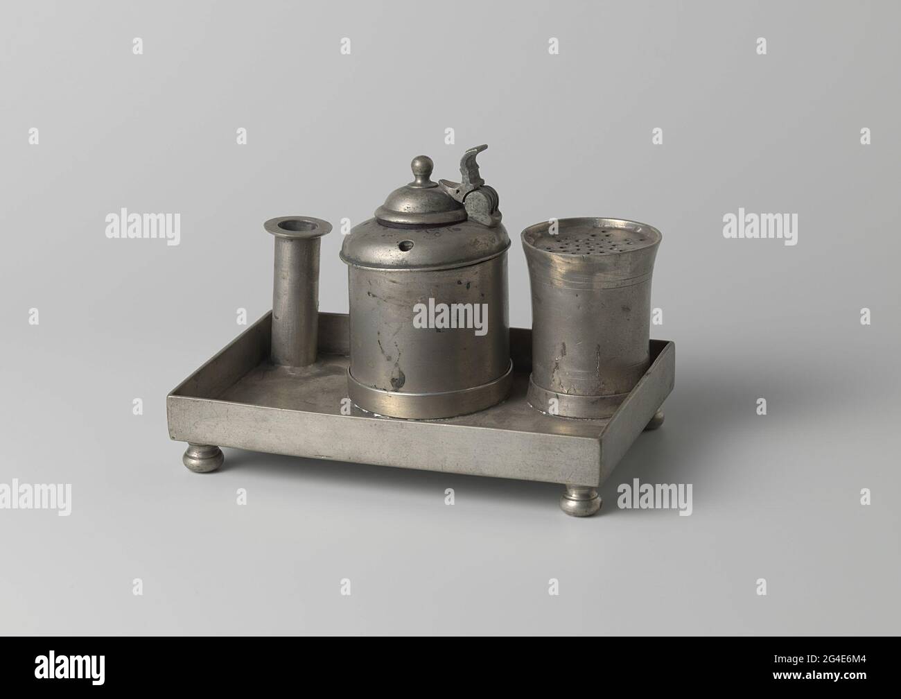 Inkwell of tin ink set. The tin inkwell has a cylindrical body. The ...