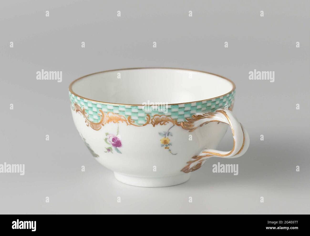. Low cup with ear, painted porcelain. The head is painted with ...