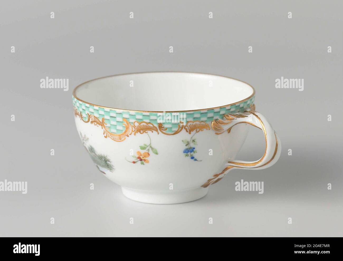 . Low cup with ear, painted porcelain. The head is painted with ...