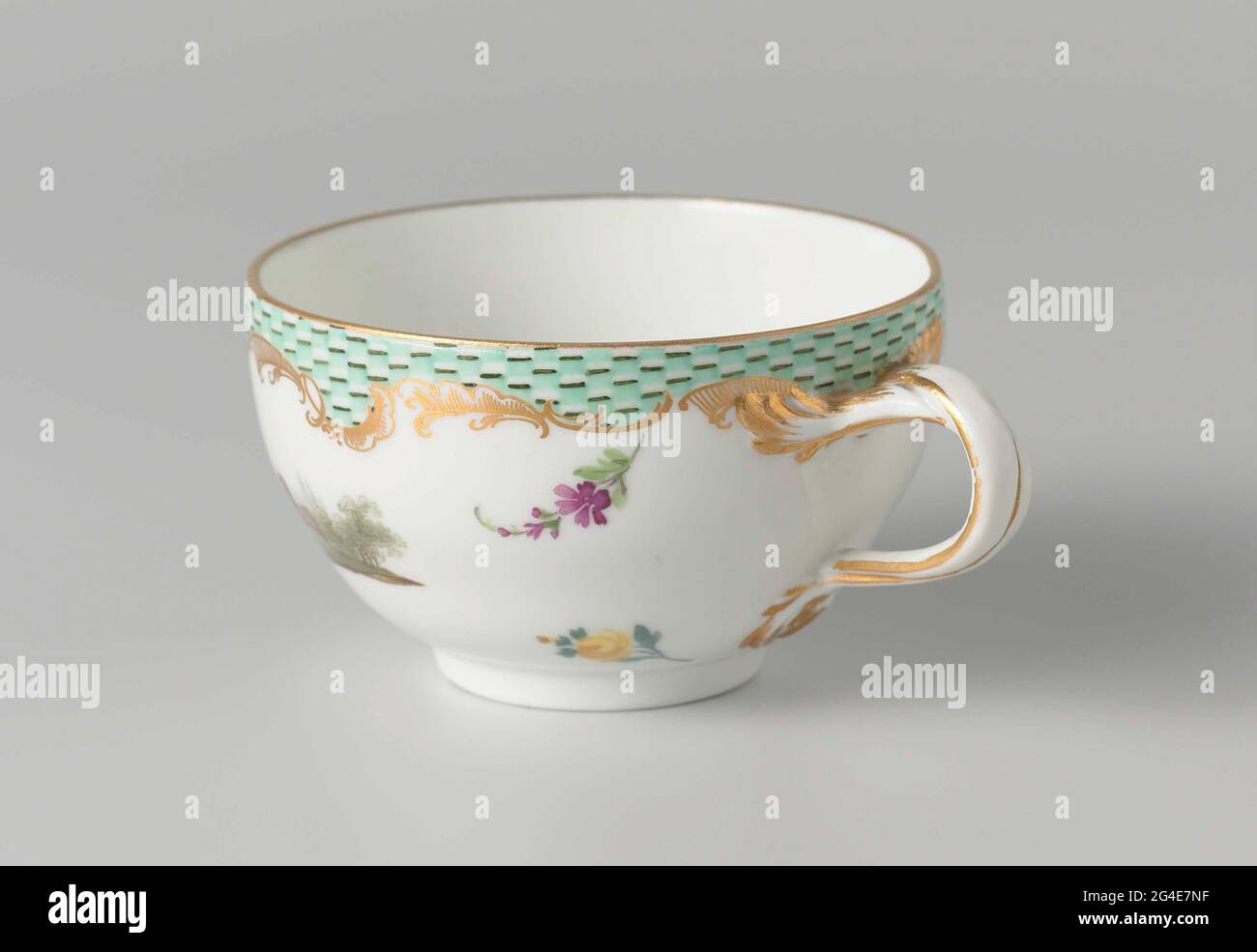 . Low cup with ear, painted porcelain. The head is painted with ...
