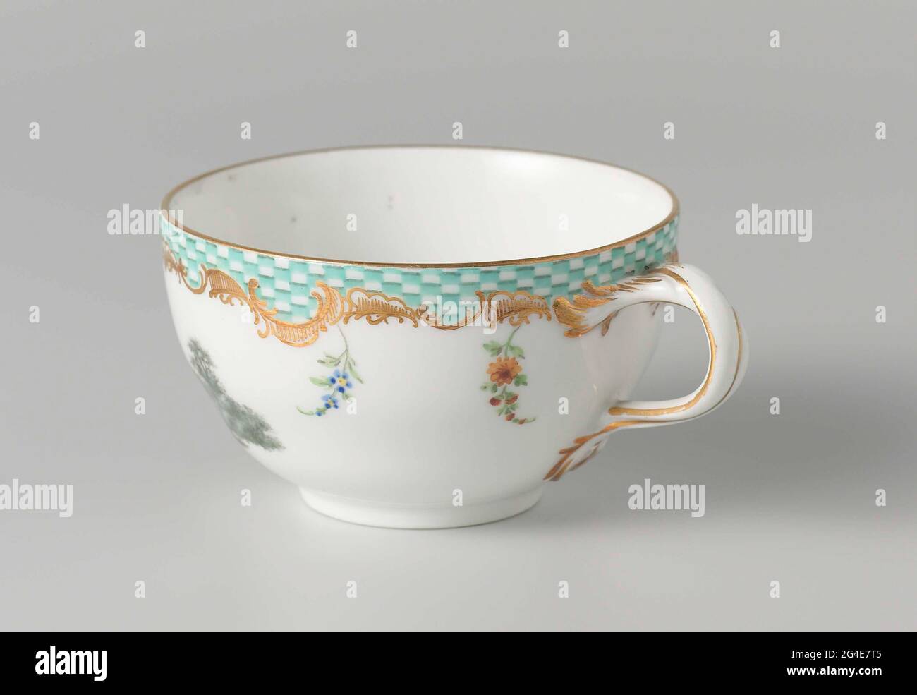 . Low cup with ear, painted porcelain. The head is painted with ...