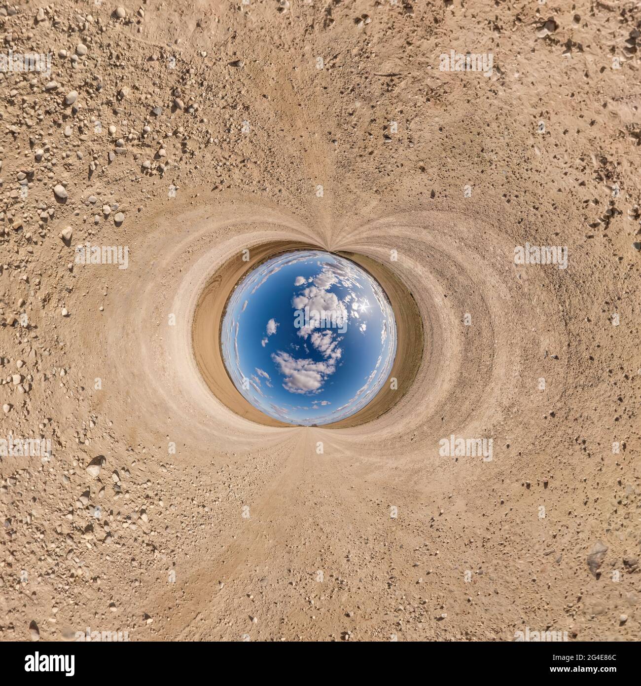 blue sky ball in middle of swirling sand road. Inversion of tiny planet ...