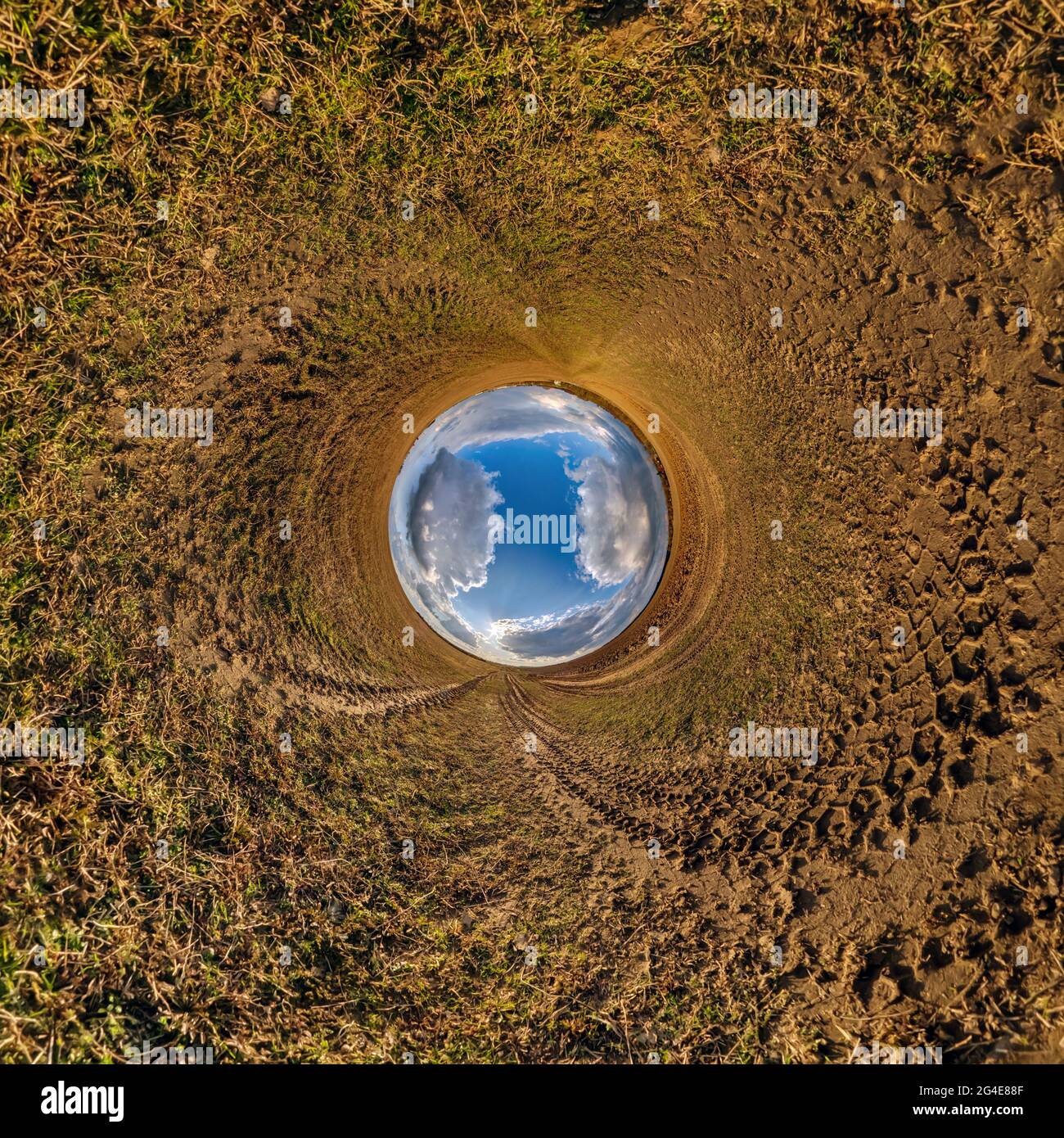 blue sky ball in middle of swirling sand road. Inversion of tiny planet ...