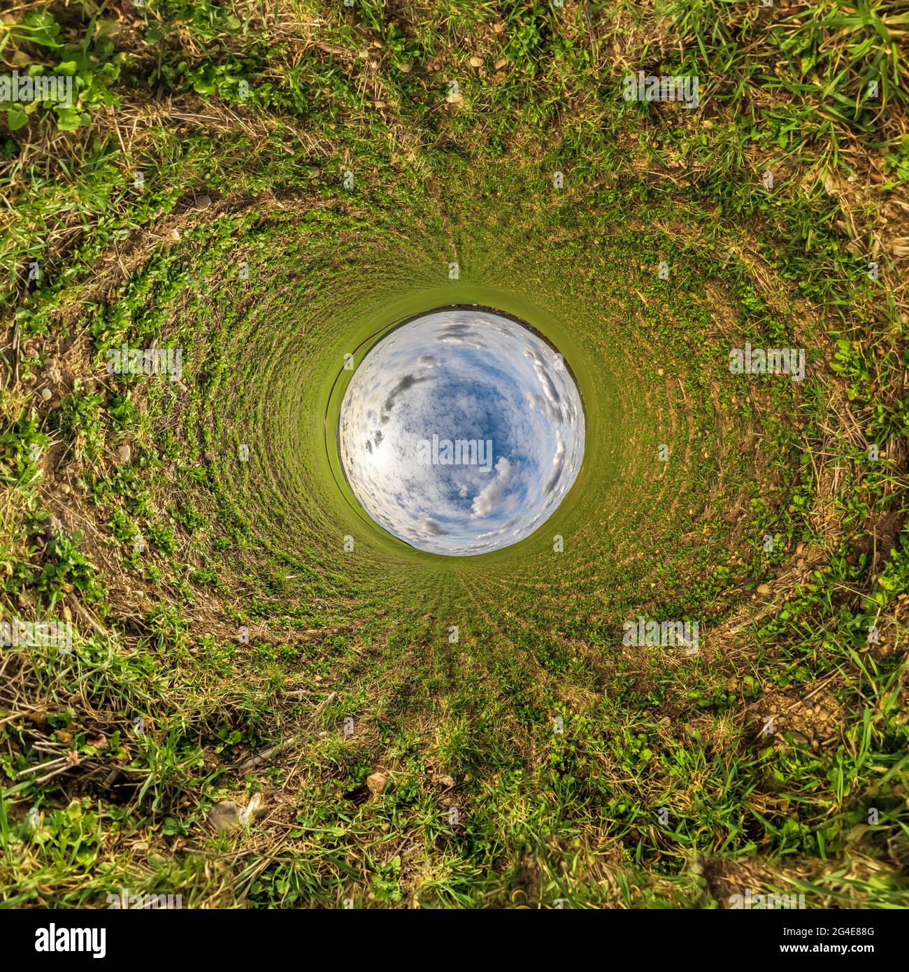 blue sky ball in middle of swirling sand road. Inversion of tiny planet ...