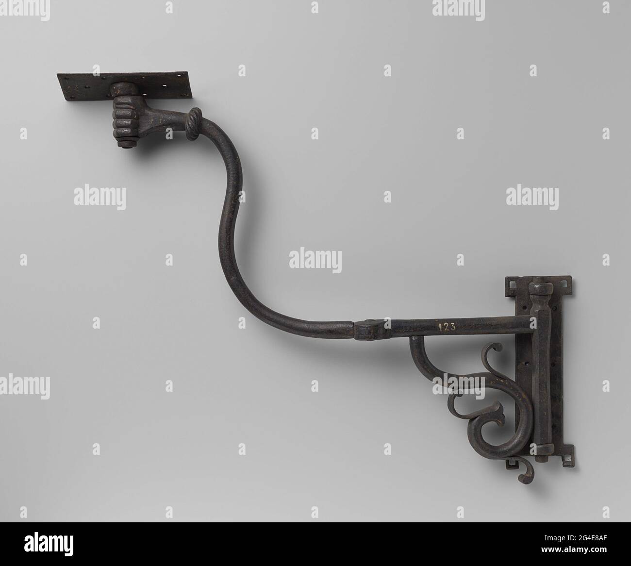 Arm of a sign in the shape of a hand. Gold-plated iron arm of a ...