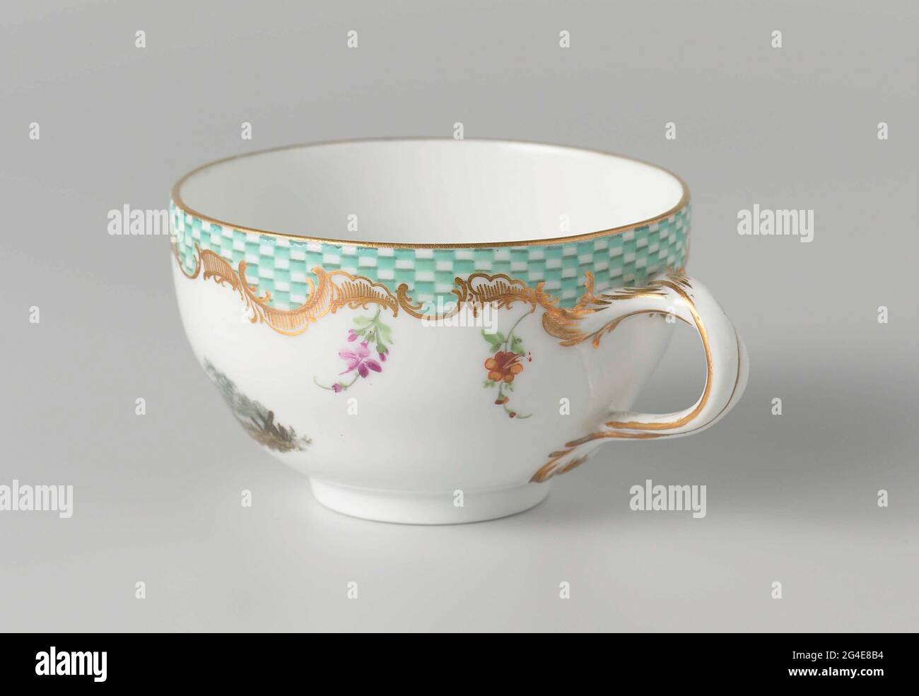 . Low cup with ear, painted porcelain. The head is painted with ...