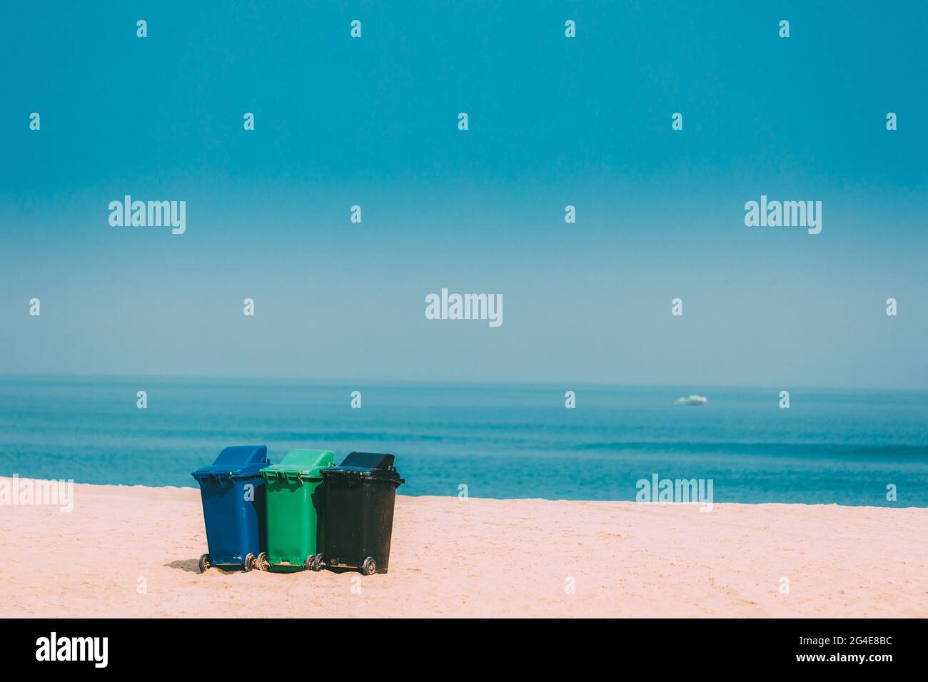 Three Colorful Plastic Waste Containers On Wheels For Separate ... Three Colorful Plastic Waste Containers On Wheels For Separate ...