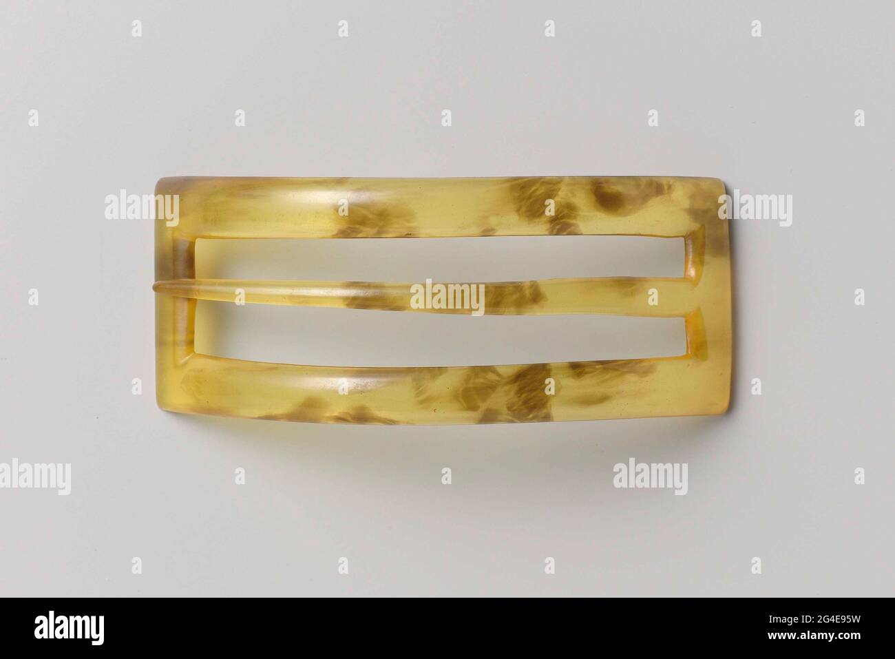 . Hairpin made of spotted golden-yellow incirected plastic in the form ...