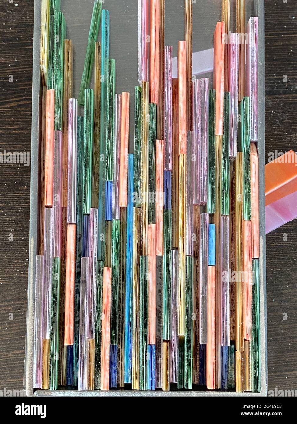 Colorful pieces of stained glass stack in a box Stock Photo - Alamy