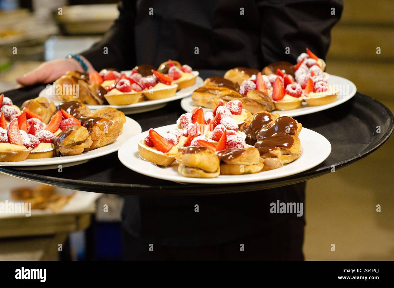 Shallow focus of a waiter serving a desserts at a restaurant Stock ...