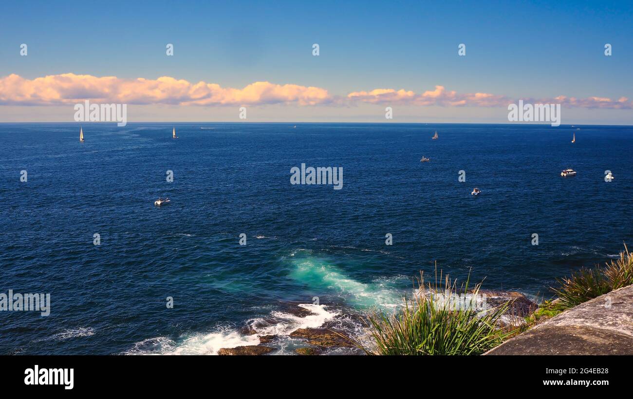 A beautiful seascape of Lady Bay out to the vast ocean with boats and ...