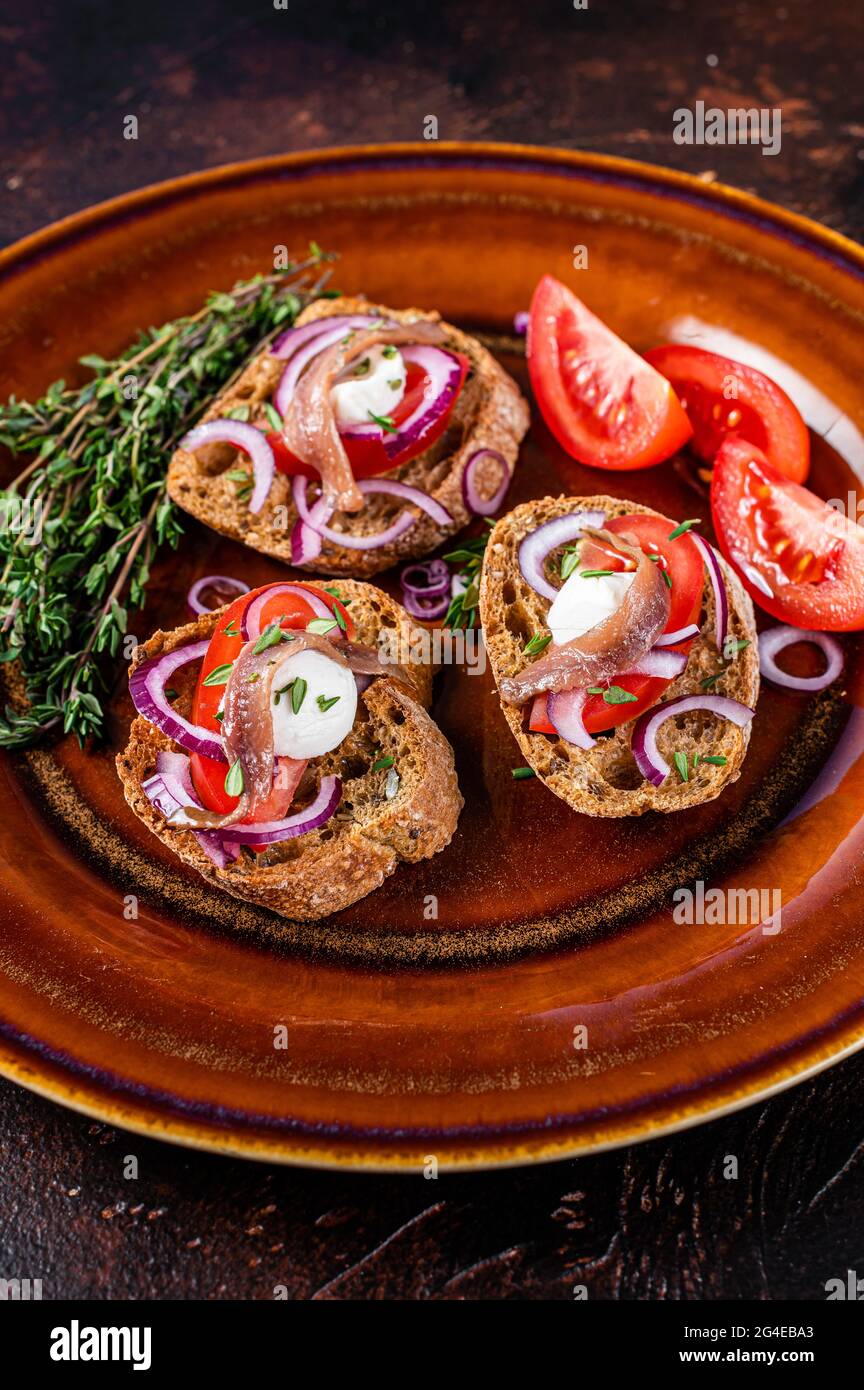 Spanish tapas on bread with olive oil, herbs, tomatoes and spicy ...