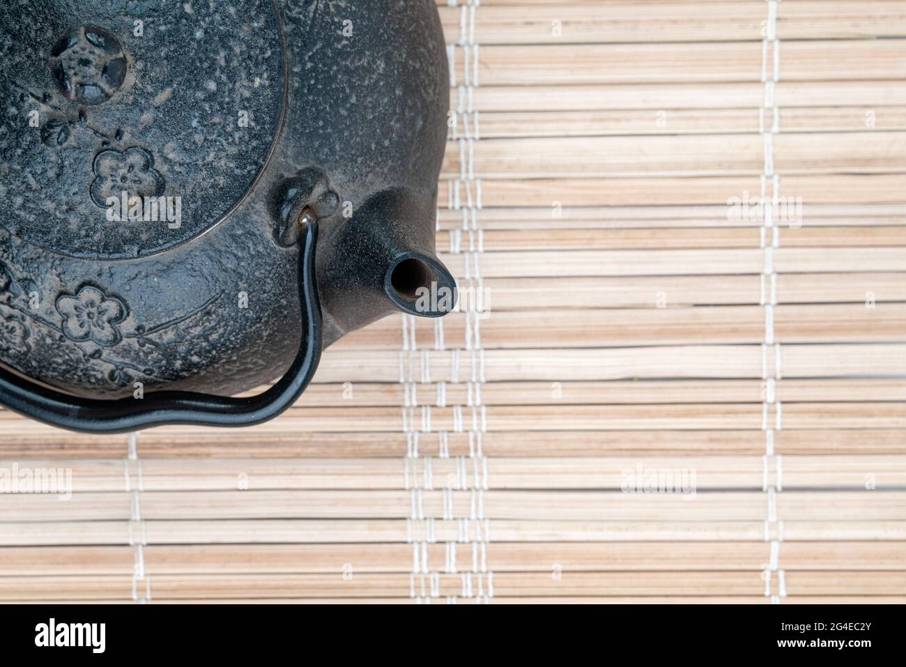 Vintage, black metal Japanese tea pot on a reed pad with a lot of free ...