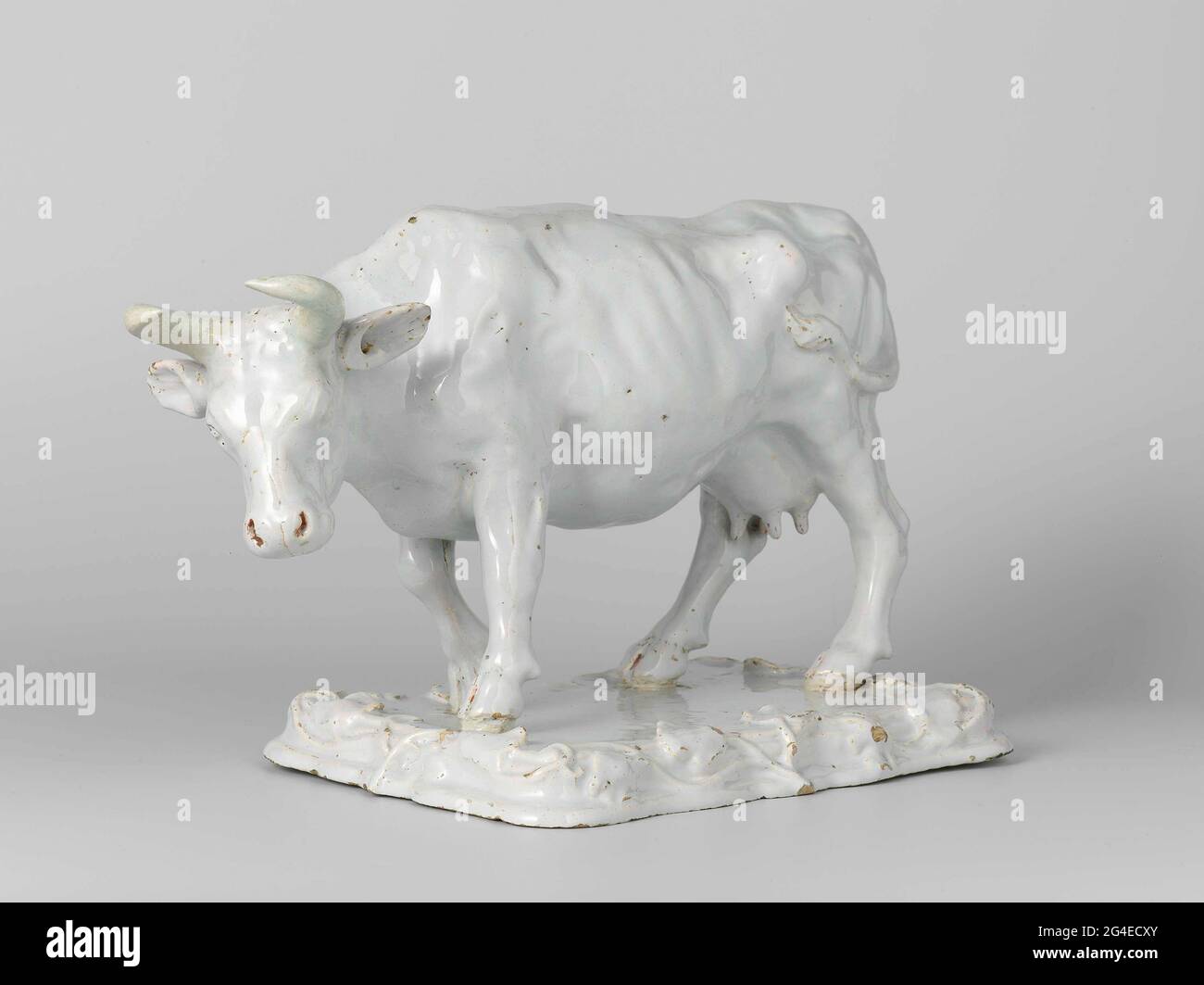 . Animal figure of faience, representing a cow. White glazed Stock ...