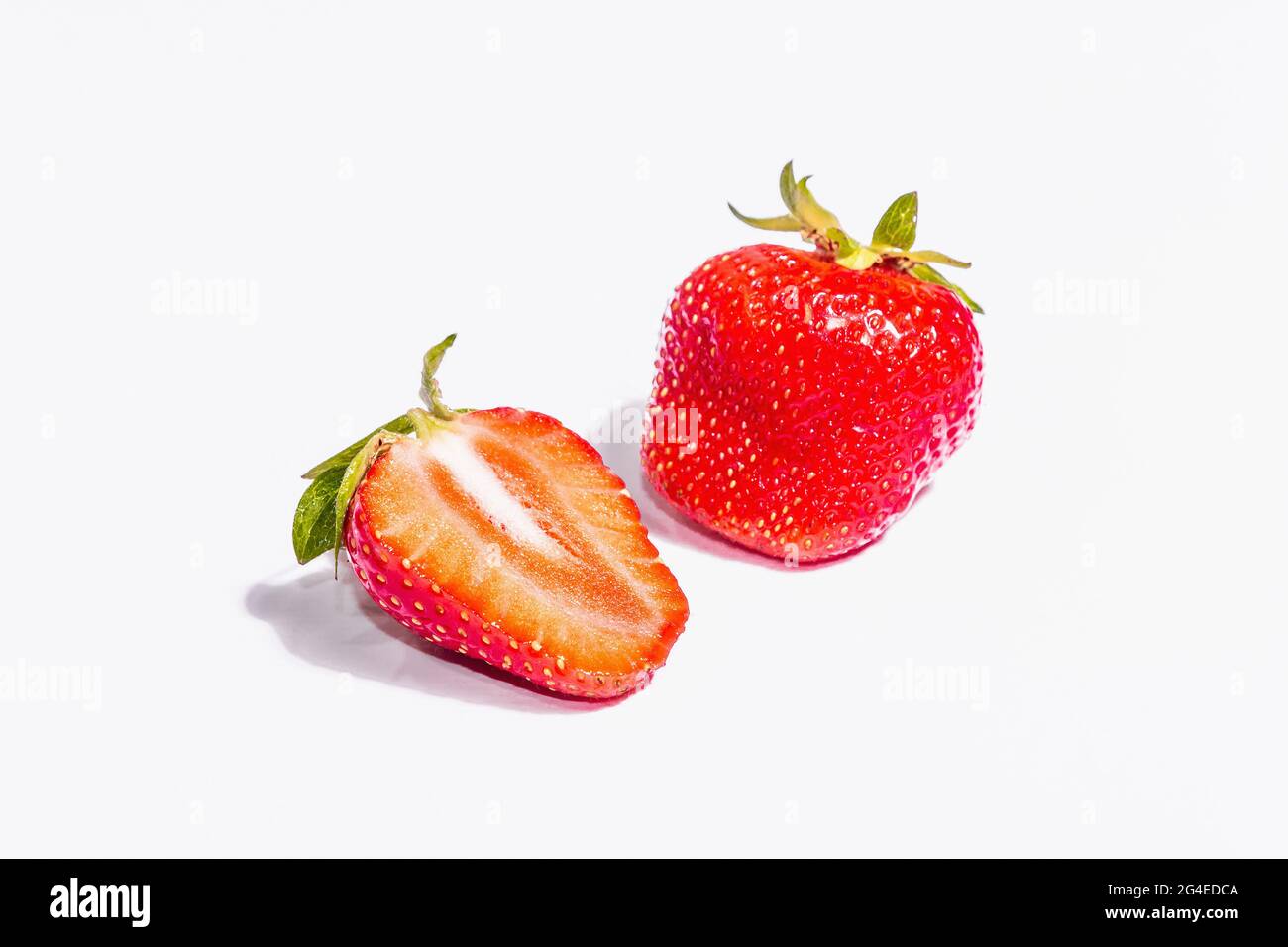 Whole and half ripe strawberry isolated on white background. Sweet ...