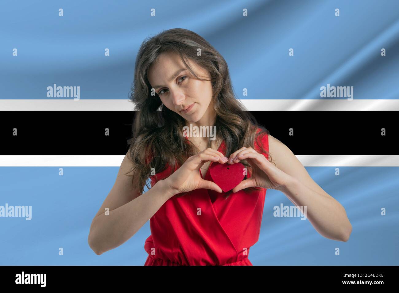 Love Botswana. A girl holds a heart on her chest in her hands against ...