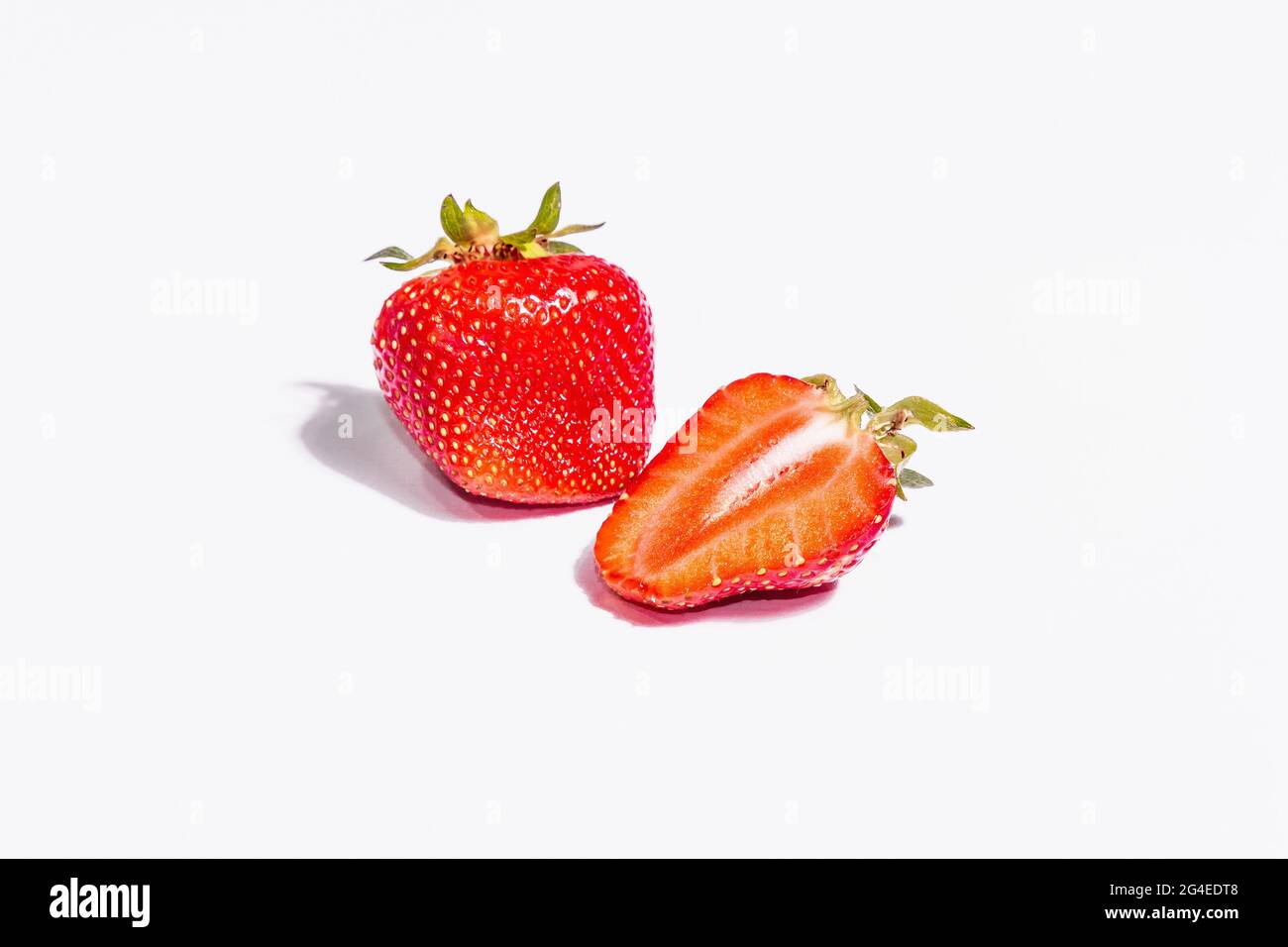 Whole and half ripe strawberry isolated on white background. Sweet ...