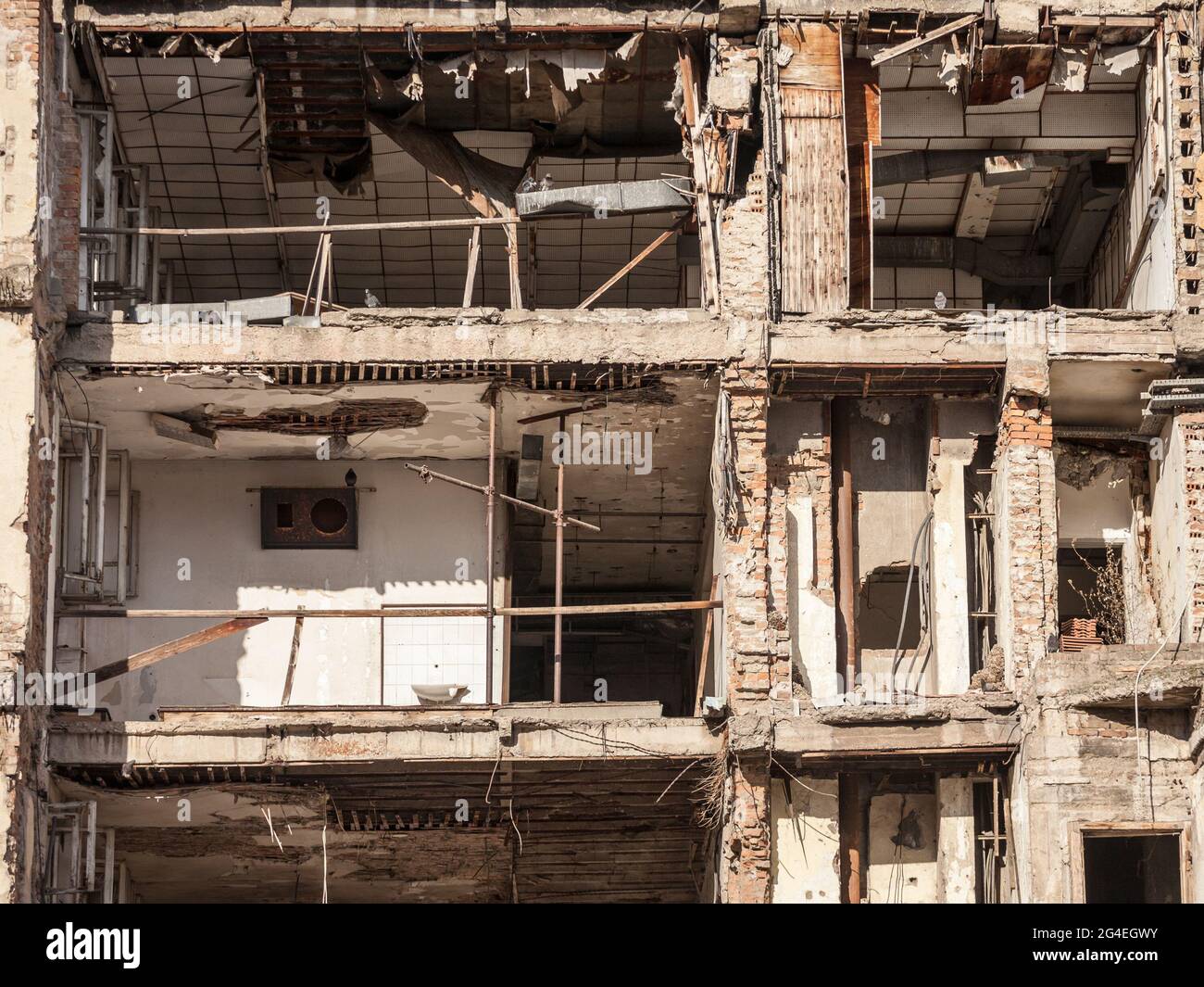 Picture of the torn down facade of an office building being demolished ...