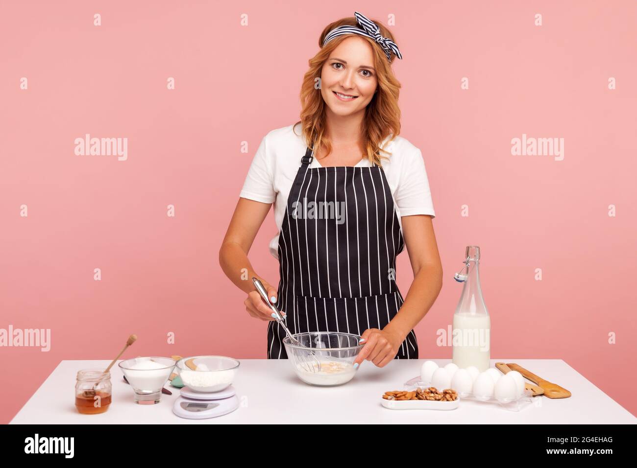 Young adult female baker with happy facial expression wearing black ...