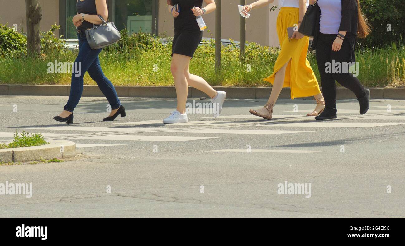 A crowd of pedestrians crossing street in the city, people walking in ...