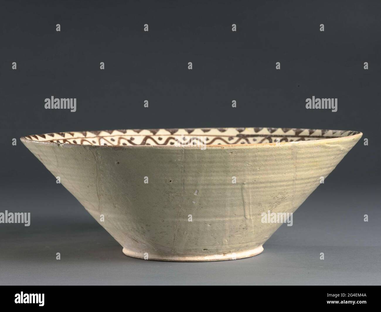 . Come of pottery decorated in black sludge on Engobe of white sludge ...