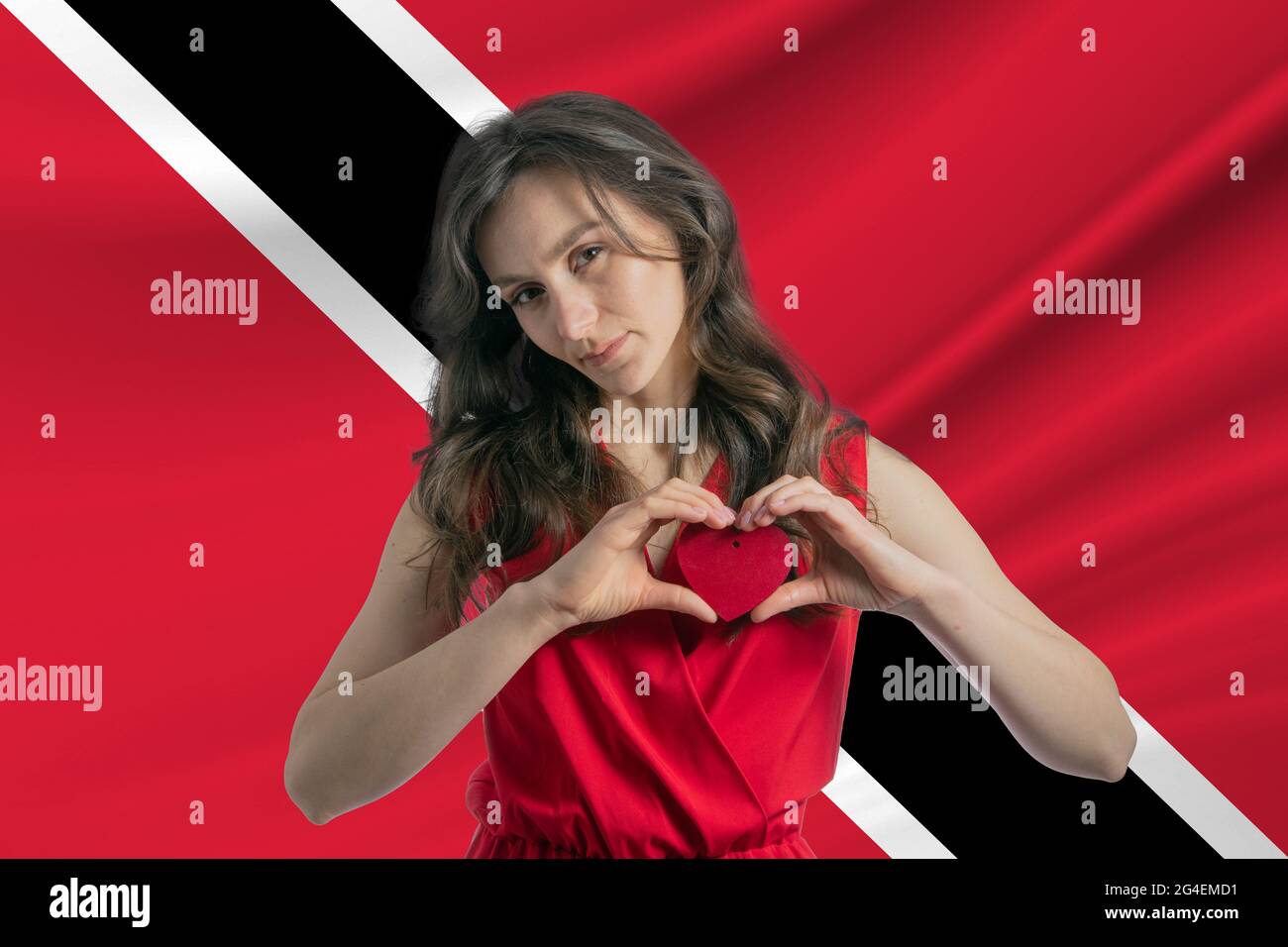 Love Trinidad and Tobago. A girl holds a heart on her chest in her ...