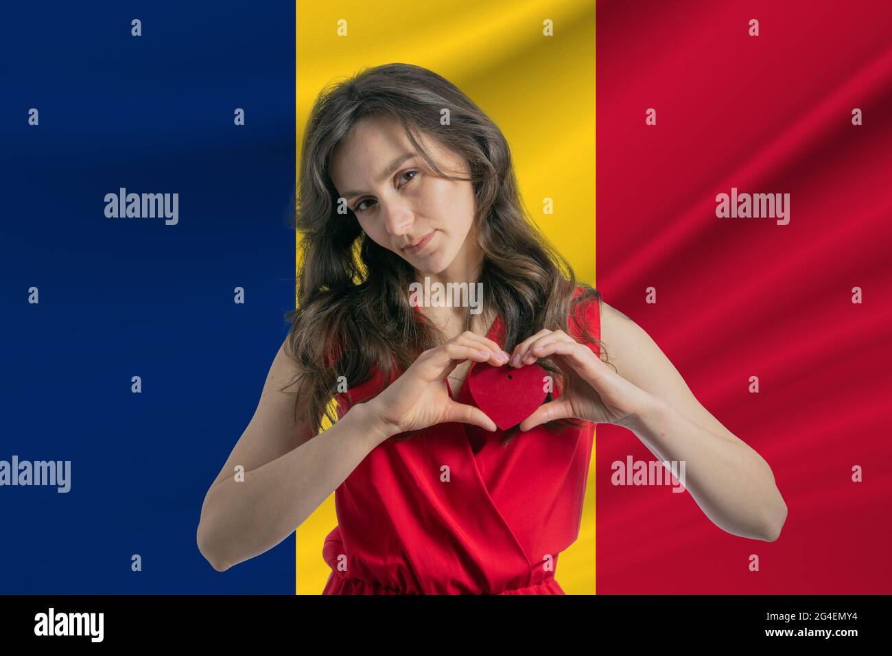 Love Chad. A girl holds a heart on her chest in her hands against the ...