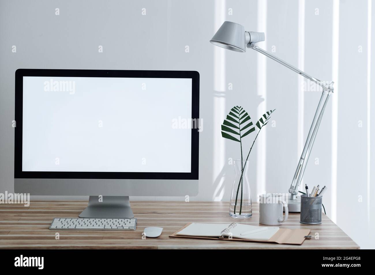 Home office desk of freelancer with lamp, opened planner and computer ...