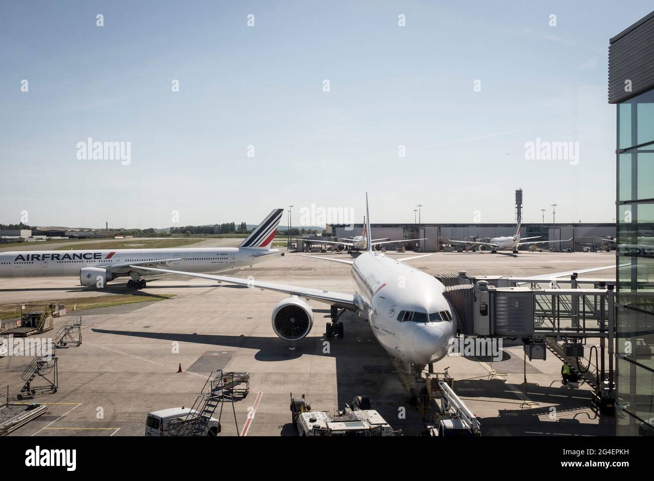 An Air France Boeing 777 plane parked at the gate as another taxis past ...