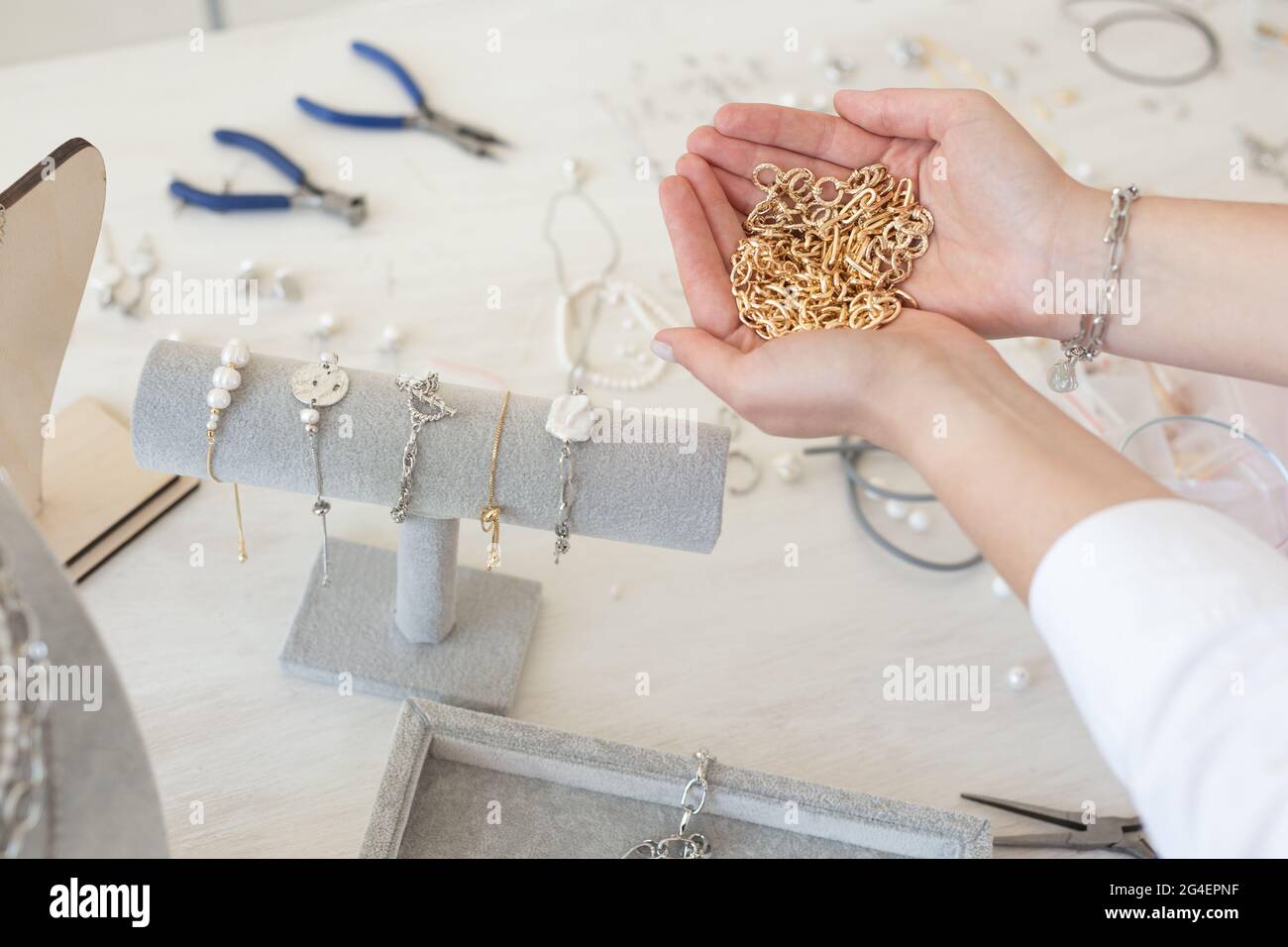 Professional jewelry designer making handmade jewelry in studio ...