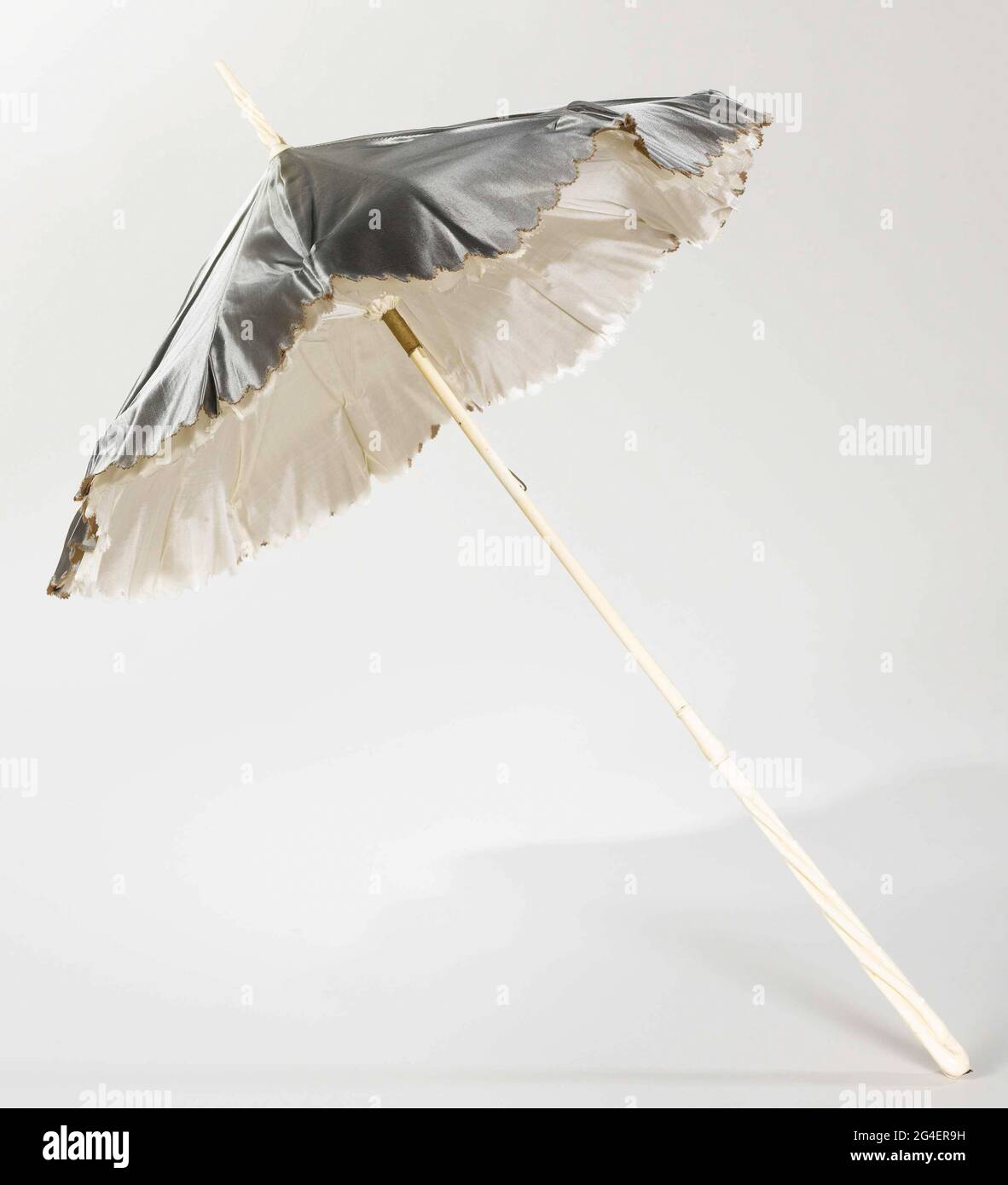 . The end of this parasol’s stick, the ivory is carved to look like two ...